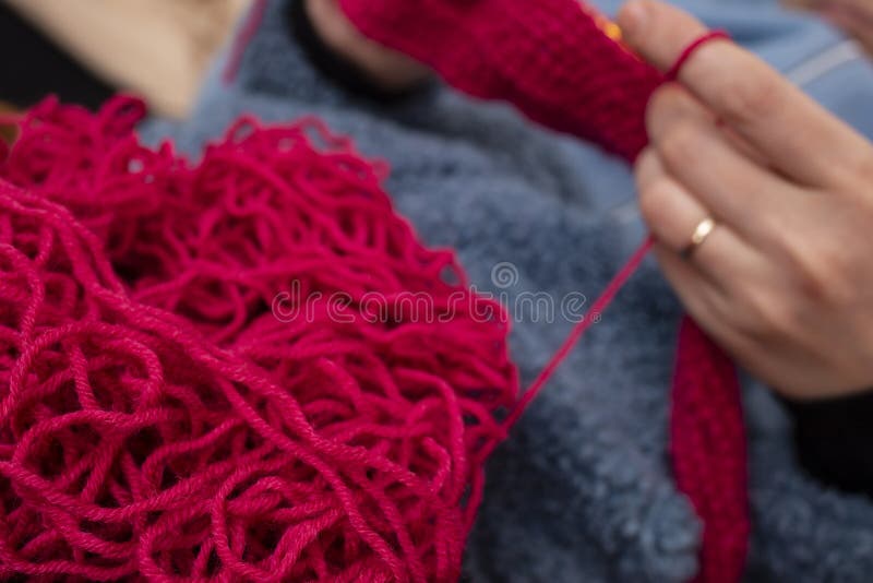 Red Tangled Thread with Defocused Womans Hands Knitting with a Crochet ...