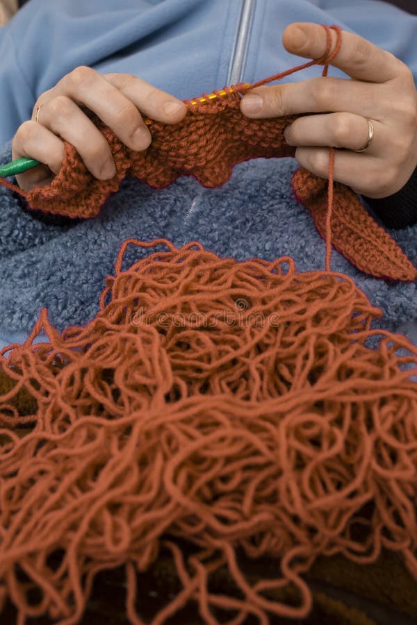 Red Tangled Thread with Defocused Womans Hands Knitting with a Crochet ...