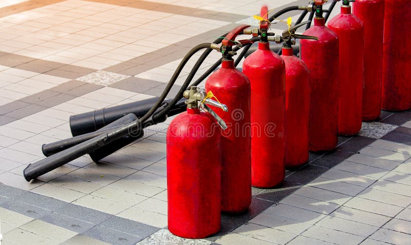 Red Tank of Fire Extinguisher on Floor, a Group of Fire Extinguisher on ...