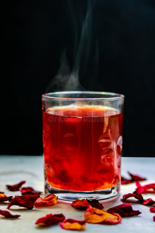 Red Tea in a Glass with Rose Petals on a Black Background Stock Image ...