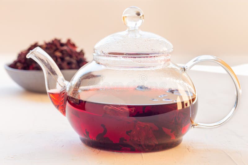 Red Tea Karkade or Hibiscus in Glass Tea Pot and on Plate, Horizontal ...