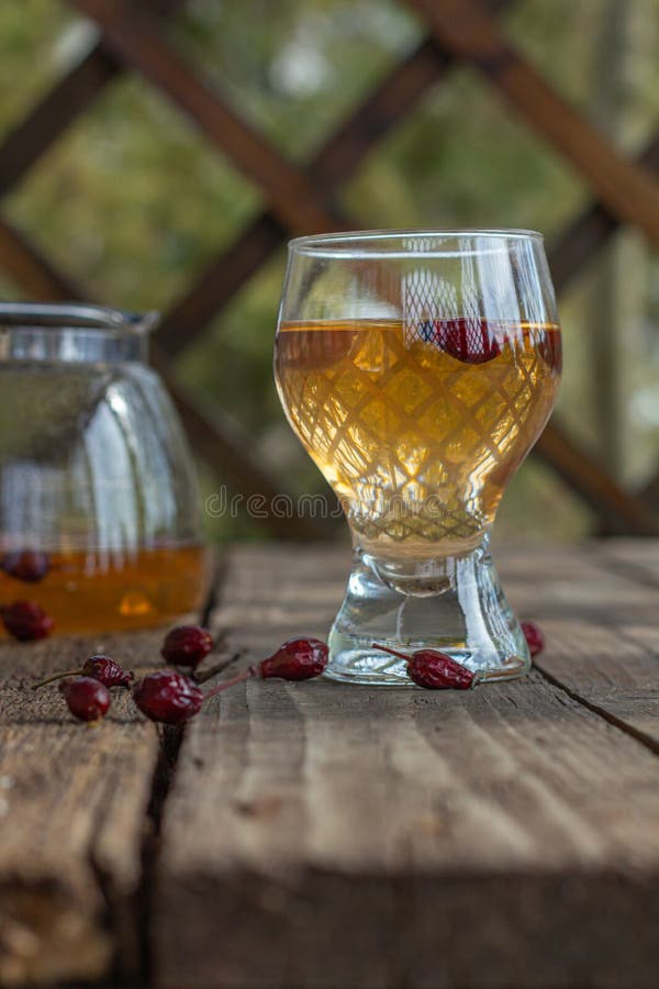 Red Tea in a Transparent Cup on a Wooden Table, Rosehip Tea, Rustic ...