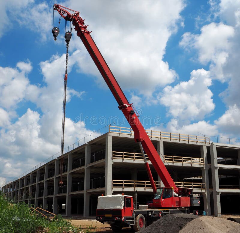 Telescopic Truck Crane in a Building Under Construction between the ...