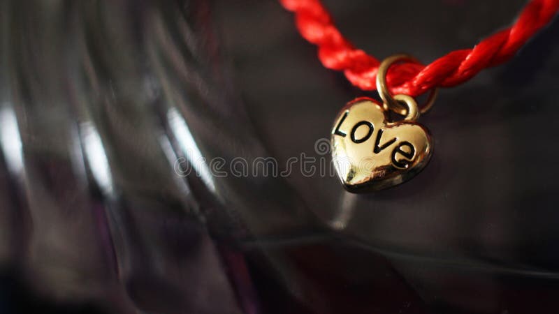 Red Thread with Gold Heart Pendant and Women`s Perfume Stock Image ...