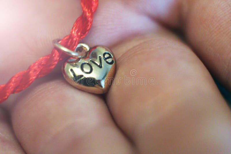 Red Thread with Gold Heart Pendant and Women`s Perfume Stock Image ...