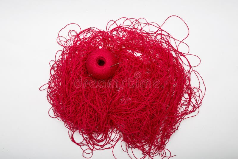 An Unwound Ball of Thread, the Thread Forms a Heart on a White ...