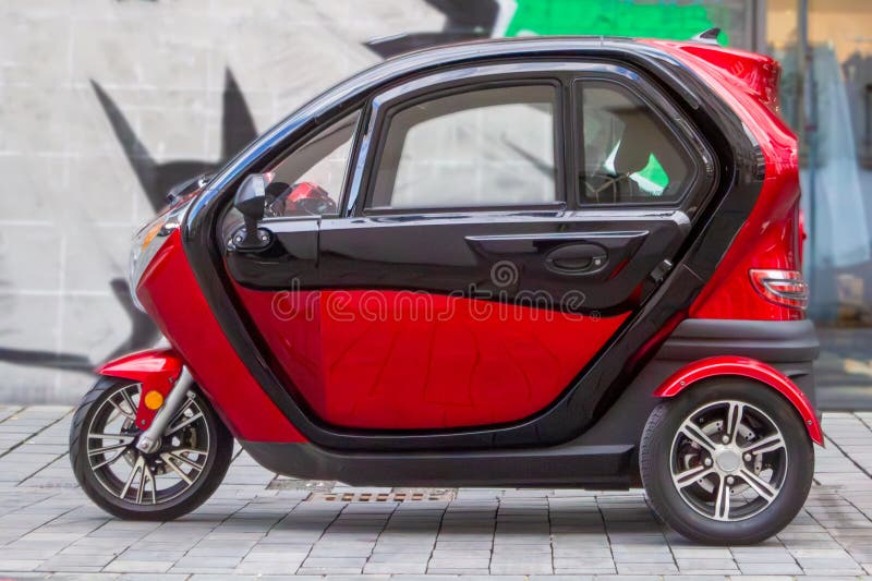 A Red Three-wheeled Car on the Background of a Painted Wall Stock Image ...
