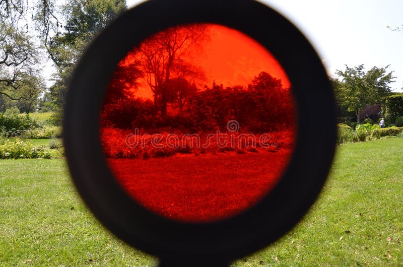 Red Tinted Magnifying Glass and Grass Lawn Stock Photo - Image of yard ...