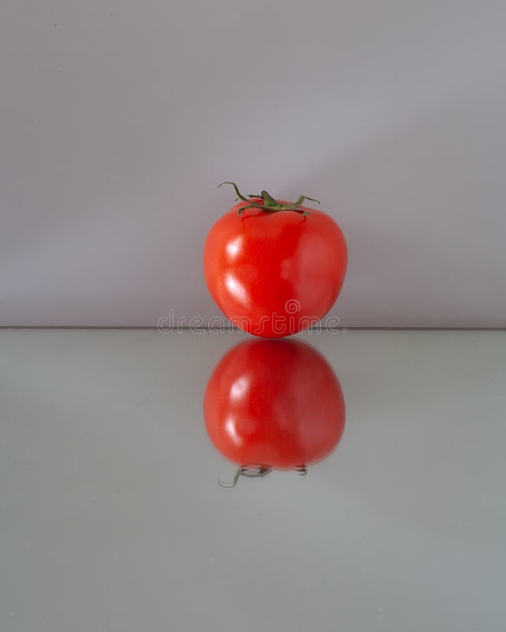 The Red Tomato is on the Mirror Table. Stock Image - Image of vitamin ...