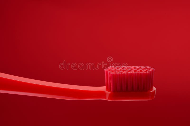 Red Toothbrush without Paste on a Red Background. Oral Hygiene of the ...