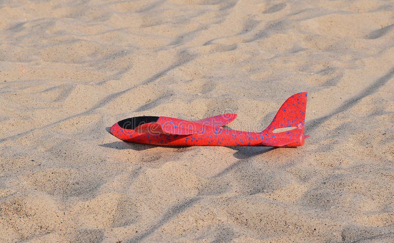 Red Toy Airplane Isolated on the Sand Stock Image - Image of statue ...