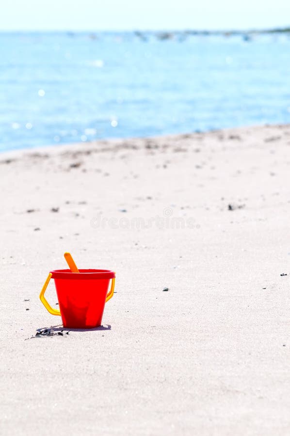 Red Toy Bucket on the Beach Stock Photo - Image of kids, enjoyment ...