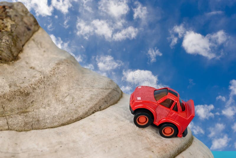 Red Toy Car Driving Up a Mountain Blue Sky with Clouds Stock Photo ...