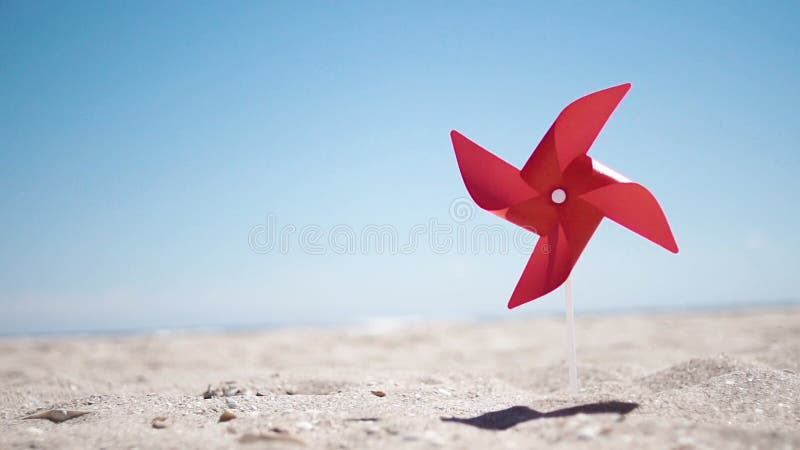 Red Toy Windmill on an Empty Sandy Beach Stock Video - Video of blue ...