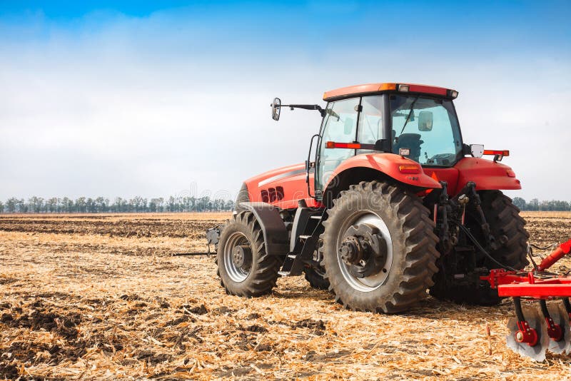 Red Tractor in the Field on a Bright Sunny Day. Stock Image - Image of ...