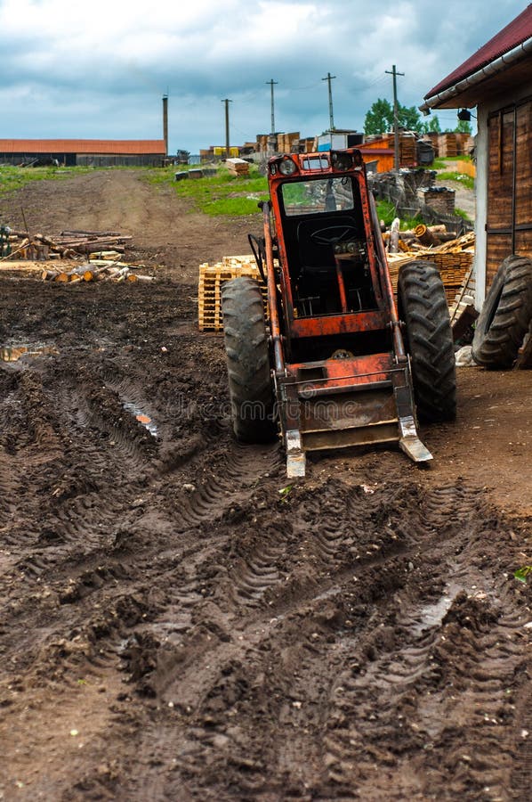 Red tractor in the mud stock photo. Image of industrial - 27269222