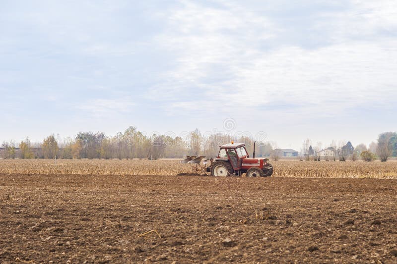 Red Tractor Plowing in Autumn Stock Image - Image of prepare, tillage ...