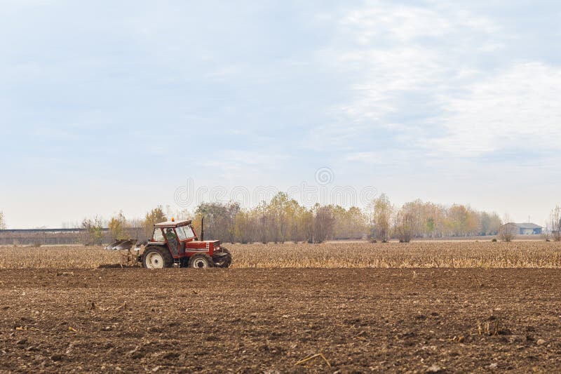 Red Tractor Plowing in Autumn Stock Image - Image of furrow, land: 64069517