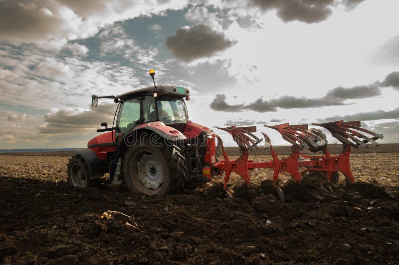 Red Tractor Plowing in Sunset Stock Image - Image of cultivated ...