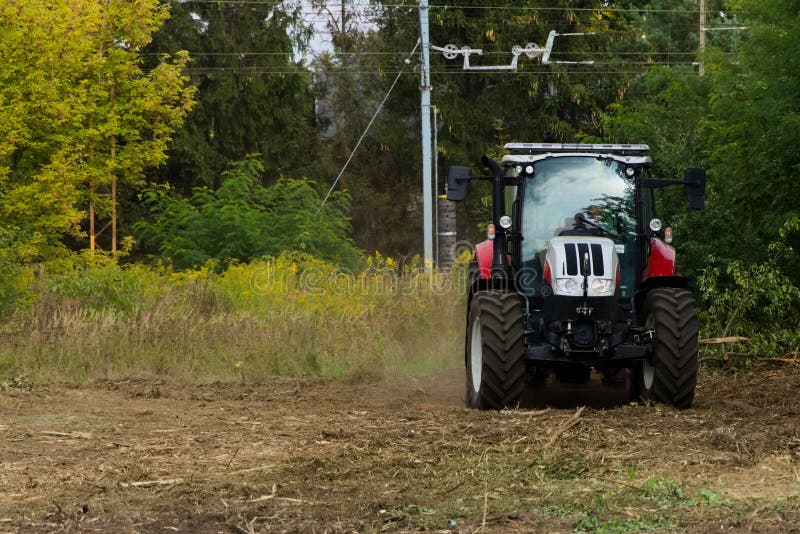 Red Tractor Working on Field. Rural Place. Stock Photo - Image of ...