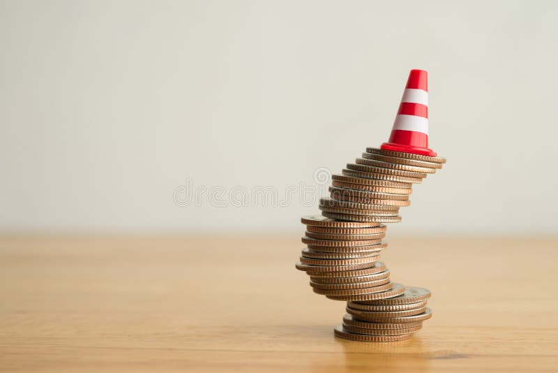 Red Traffic Cone on Stack Coins in Uncertainty Situation on Wooden ...