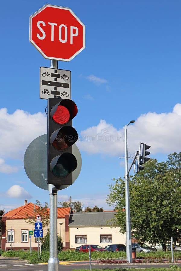 Stop Sign and Green Light at the Road Crossing Stock Photo - Image of ...