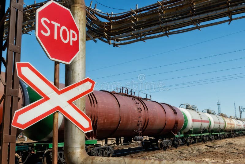 Red Traffic STOP Sign in Front of the Train Moving in the Background ...