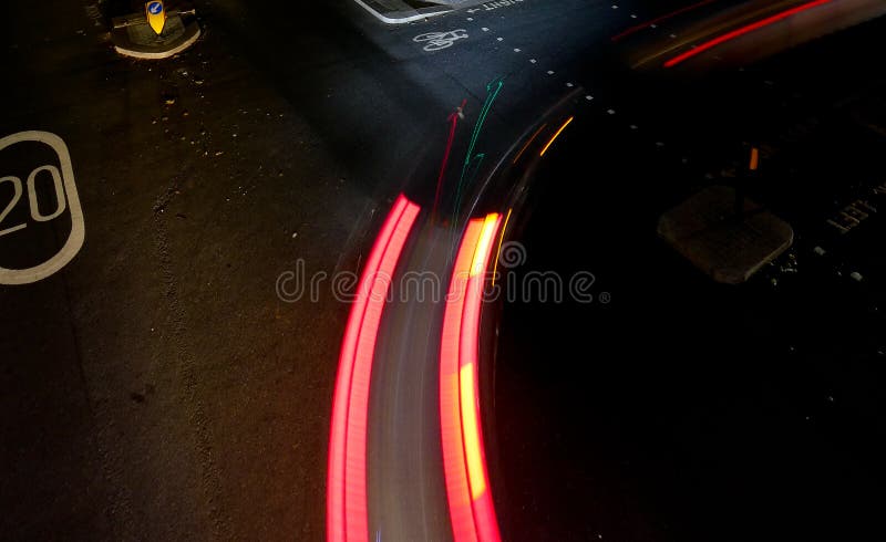 Red Traffic Trails at Night with 20 Mph Speed Limit Sign on Road Stock ...