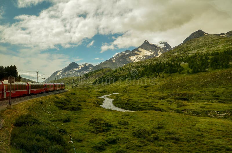 Red Train through the Alps in Switzerland Stock Image - Image of trees ...