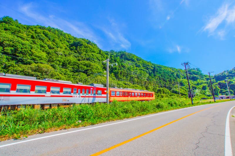 Red Train and Road Surrounded by Greenery Stock Image - Image of ...
