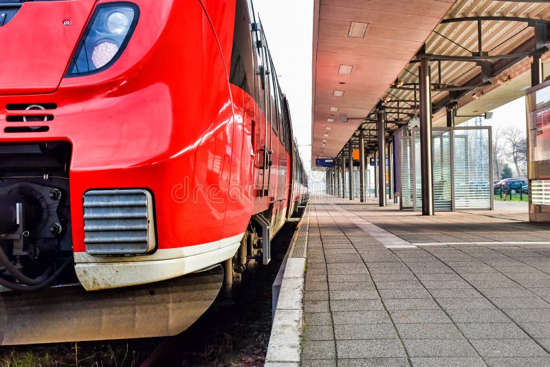 A Red Train is Waiting at an Empty Platform for Departure Stock Image ...