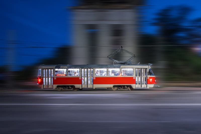 A Red Tram Moves Fast in the Evening with a Blurred Background Stock ...