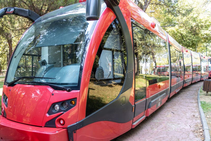 Red Tram on the Tree-lined Road. Environmentally Clean Public ...