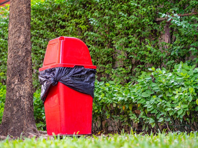 Red trash bin in the park stock photo. Image of metal - 188363528