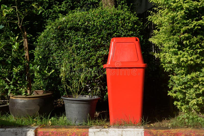 Red Garbage Bin on the Grass Stock Image - Image of environment ...