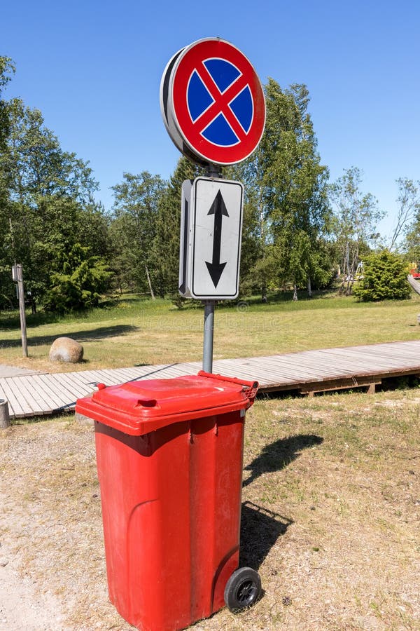 .a Red Trash Can and a Road Sign with Red Circles and Blue Colors Stock ...