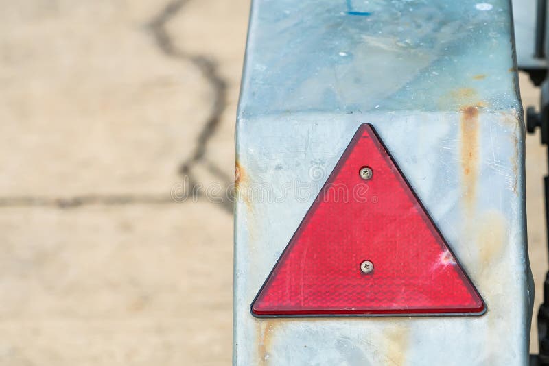 Red Triangle Shaped Safety Reflector on Rusty Metal Surface Stock Photo ...