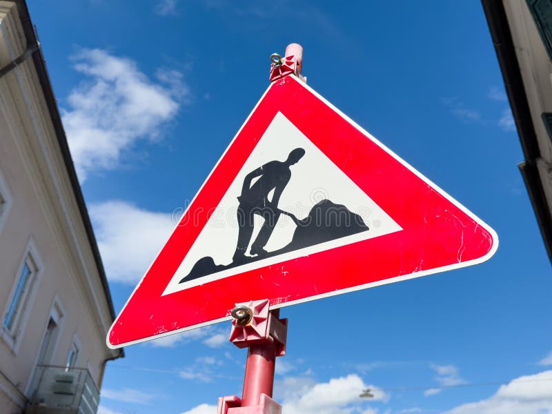 Red Triangular Construction Warning Sign Against Blue Sky Stock ...
