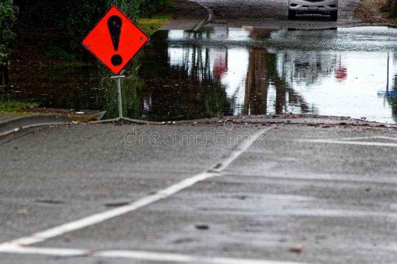 A Red, Triangular Flood Water Sign with a Black Exclamation Mark Warn ...