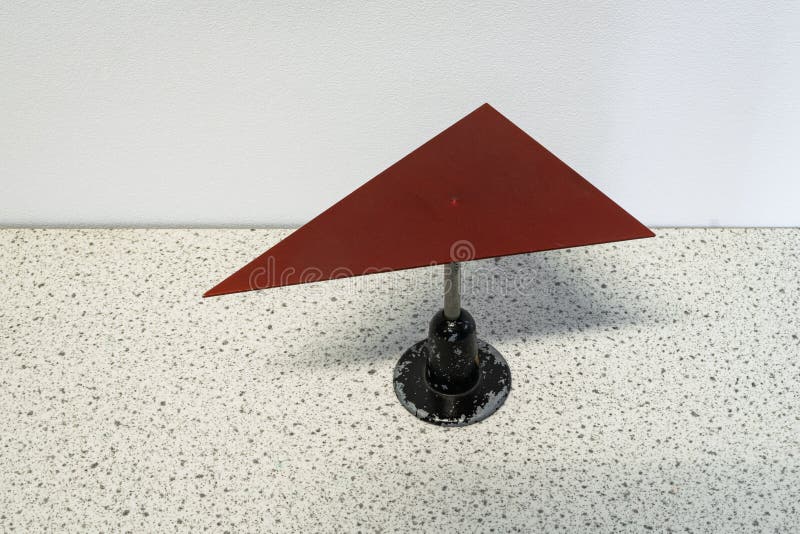 Red Triangular Metal Plate is Balancing on a Needle Stock Photo - Image ...
