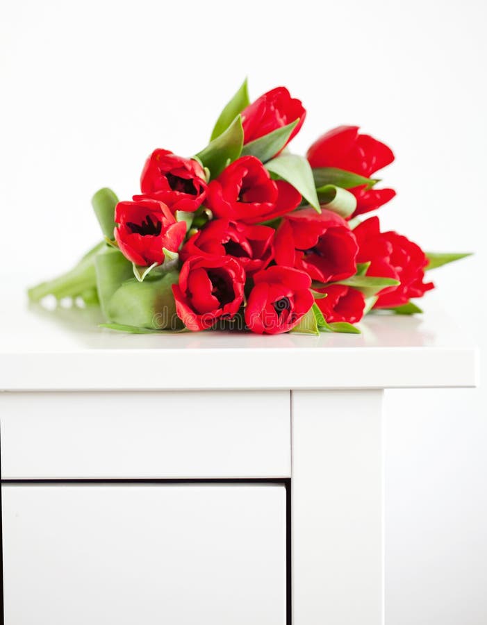 Red Tulips Lying on White Table Stock Image - Image of elegant ...