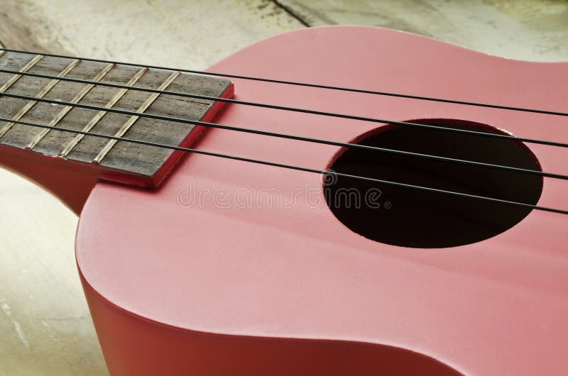 Red Ukulele on Wooden Table Stock Photo - Image of note, bridge: 31779256