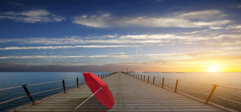Red umbrella on the pier stock photo. Image of scenic - 157386166