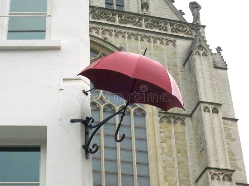 Red Umbrella on a Wall of a Building Near the Cathedral of Antwerpen ...