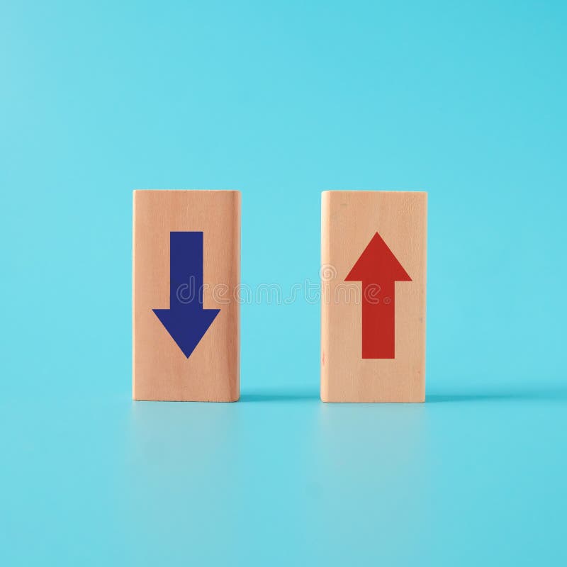 Red Up Arrow in Bright Side and Blue Down Arrow on Wooden Cube Stock ...