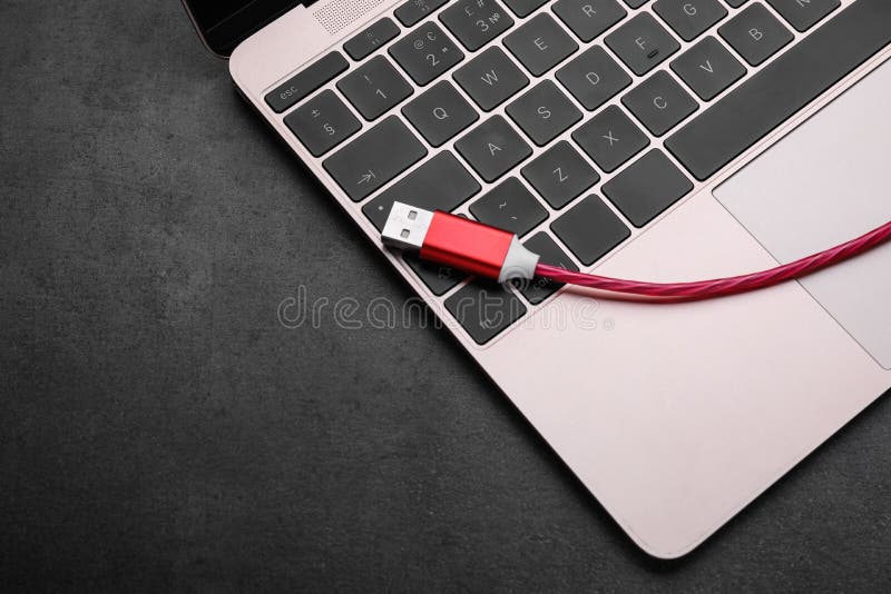 Red USB Cable and Laptop on Dark Table, Top View. Space for Text Stock ...