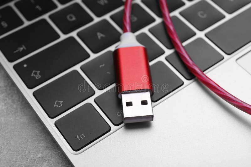 Red USB Cable and Laptop on Grey Table, Closeup Stock Image - Image of ...