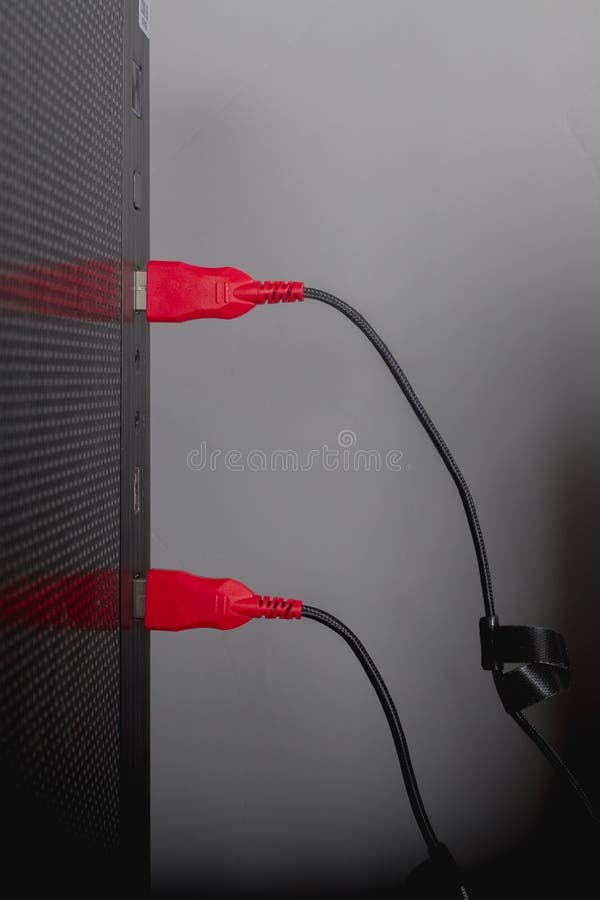 The Red USB Cord is Inserted into the USB Port of the Computer Stock ...