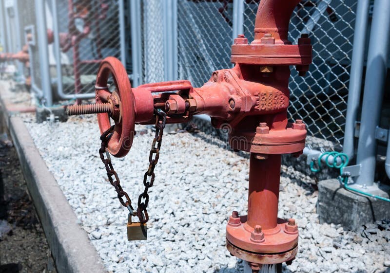 Red Valve Hydrant is Lock by Key and Chain Stock Image - Image of chain ...