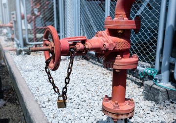 Red Valve Hydrant is Lock by Key and Chain Stock Image - Image of chain ...